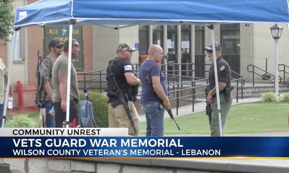 Armed veterans stand guard at memorial against 'violent thugs' who ...