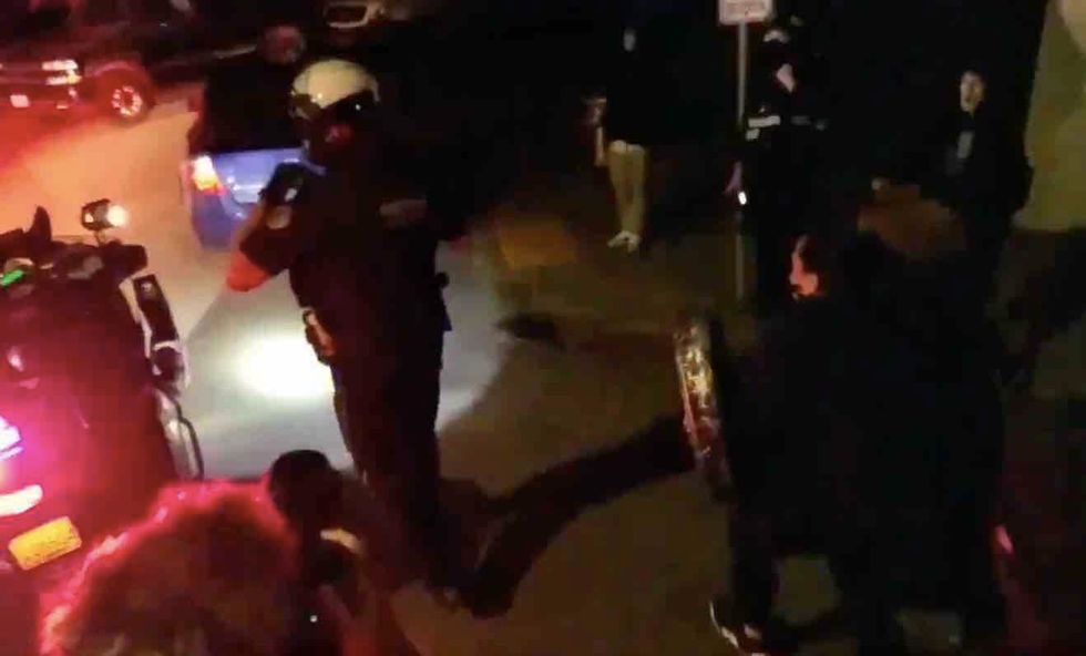 VIDEO: Cop drives motorcycle into protester blocking his path, pushing ...